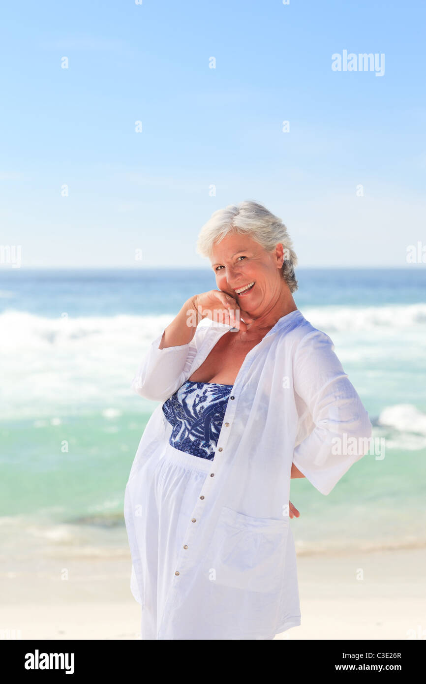 Happy retired woman on the beach Stock Photo - Alamy