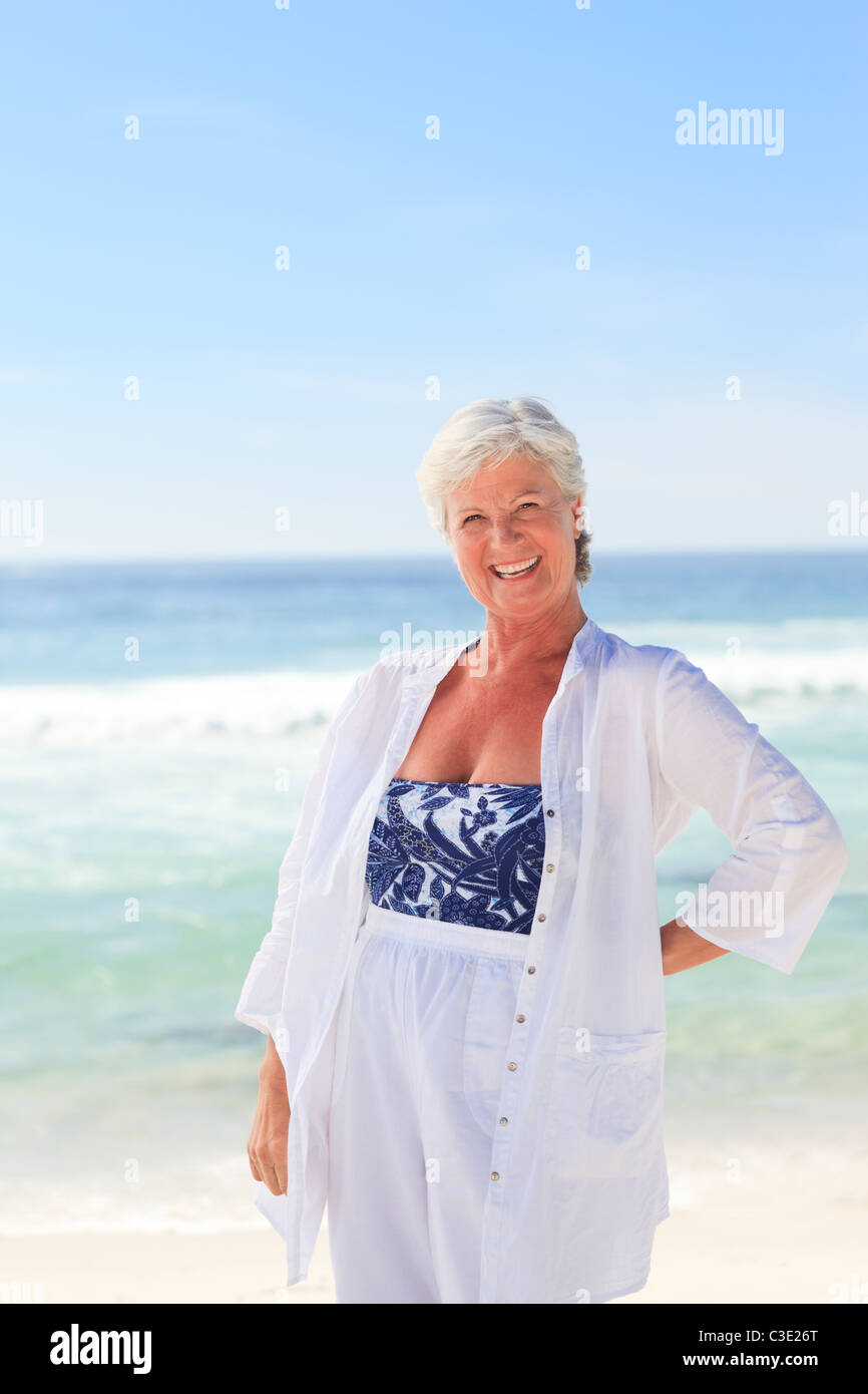 Happy retired woman on the beach Stock Photo - Alamy