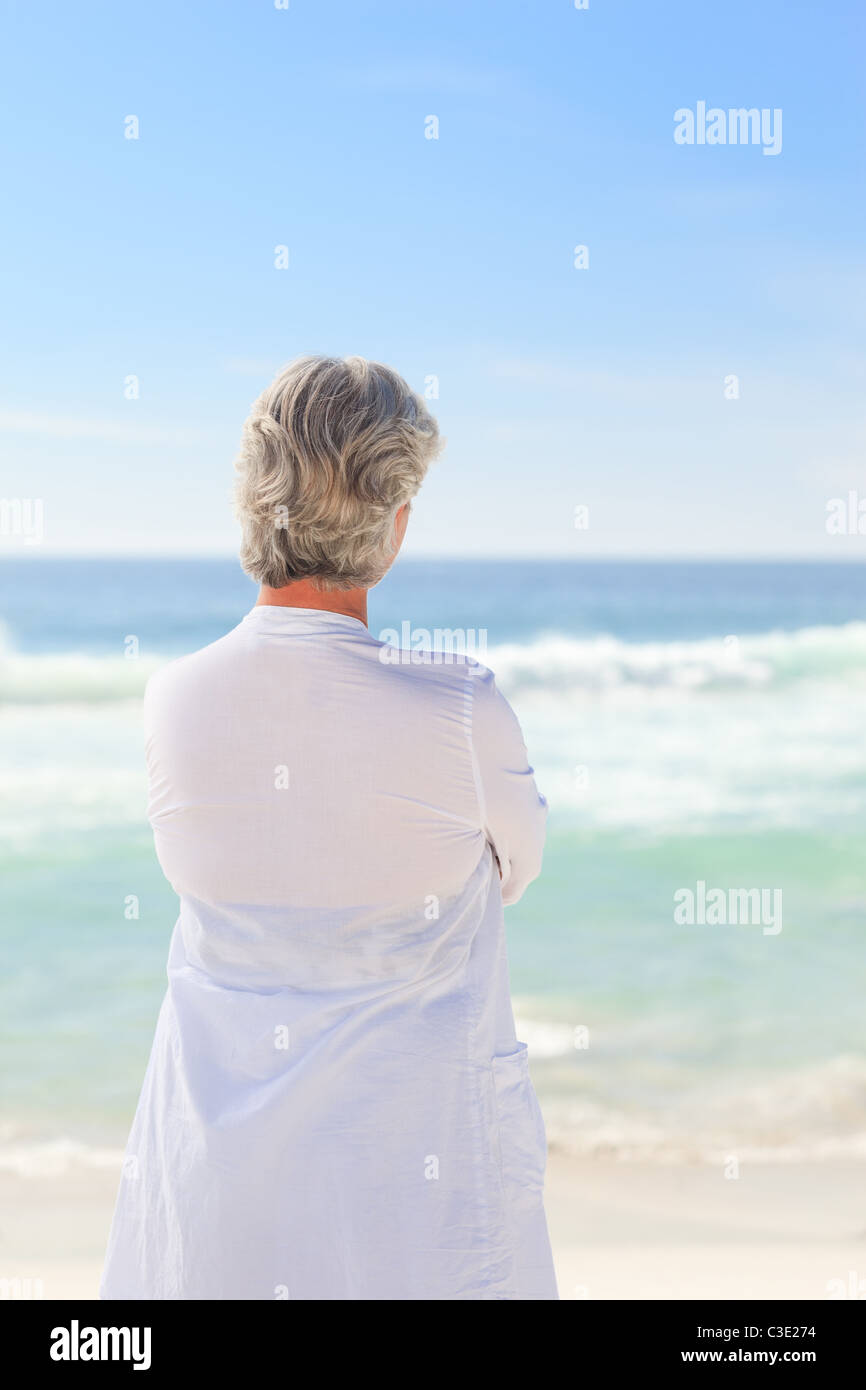 Happy retired woman on the beach Stock Photo - Alamy