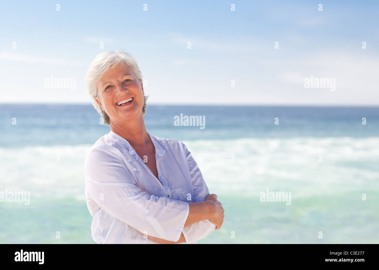 Happy retired woman on the beach Stock Photo - Alamy