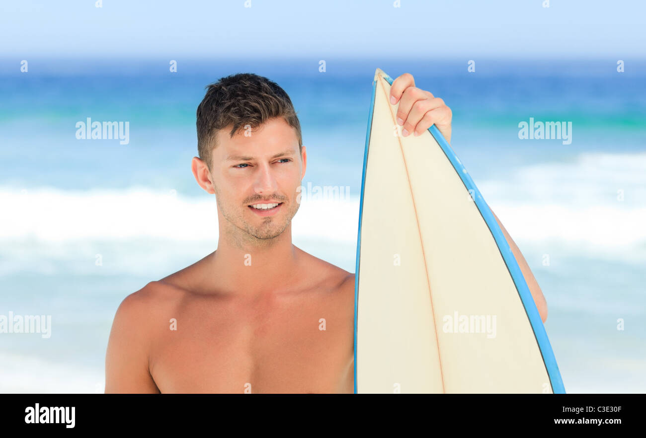 Handsome man with his surfboard Stock Photo - Alamy