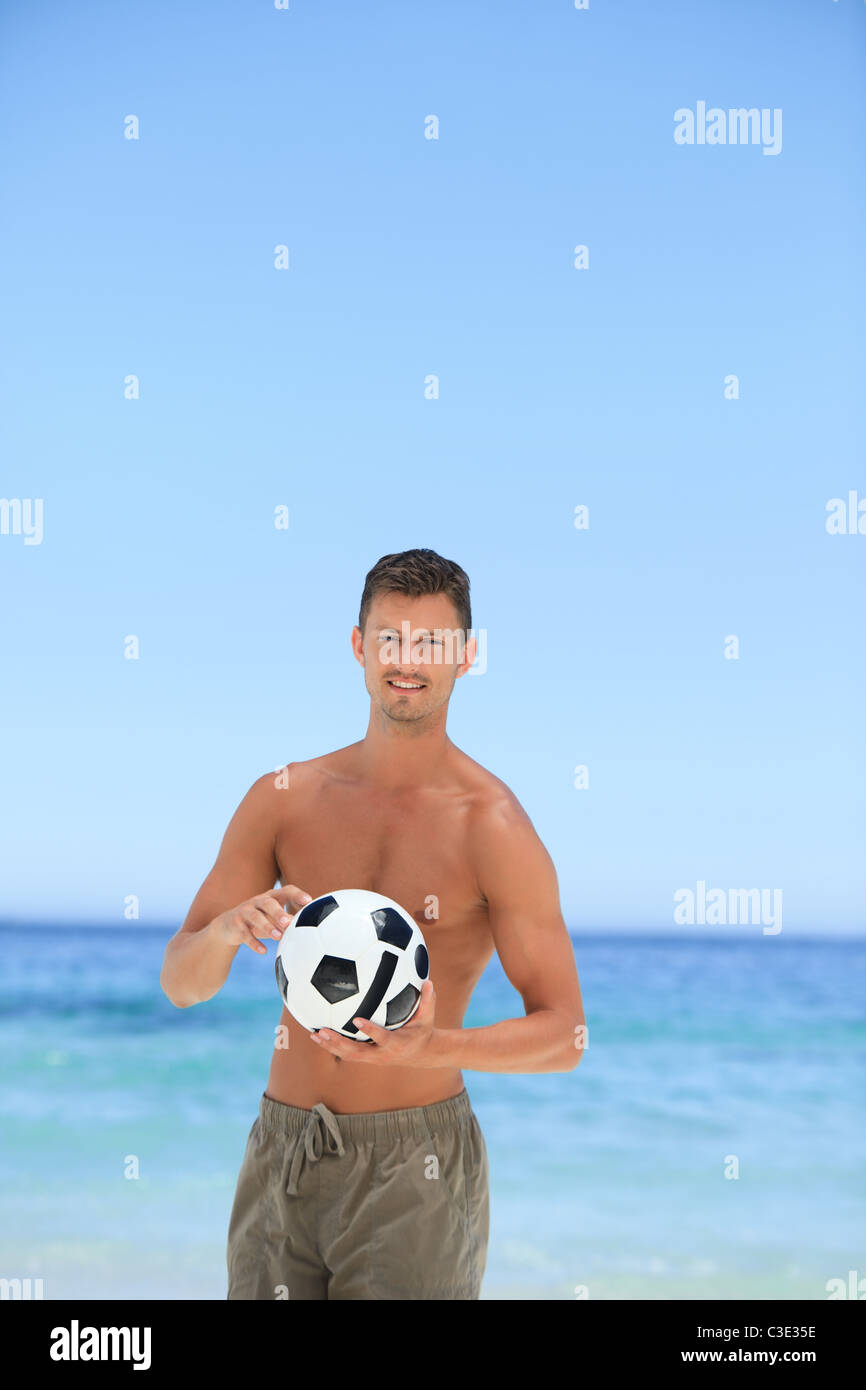 Man with his ball at the beach Stock Photo - Alamy