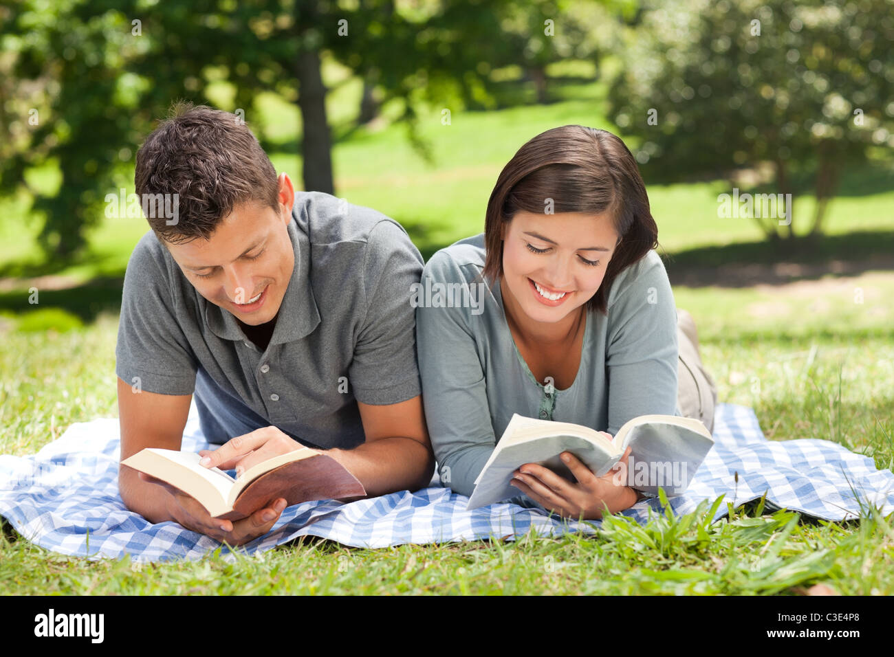 Couple reading a book Stock Photo - Alamy