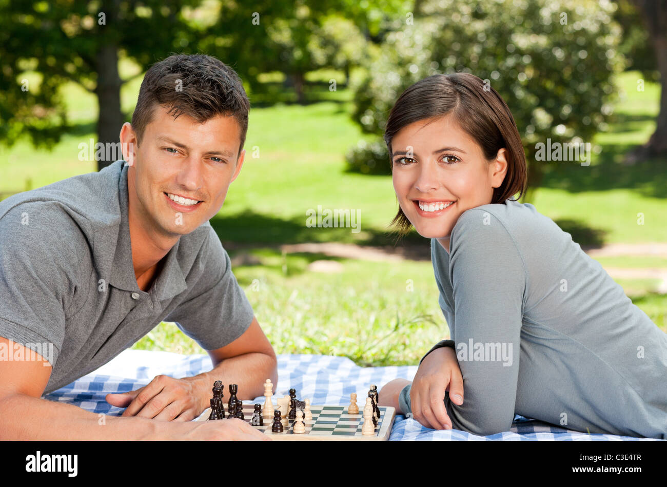 Couple playing chess in the park Stock Photo - Alamy