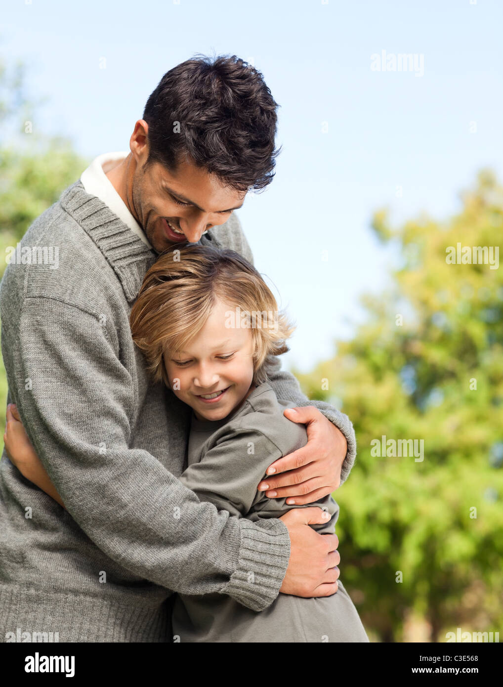 Son embracing his father Stock Photo - Alamy