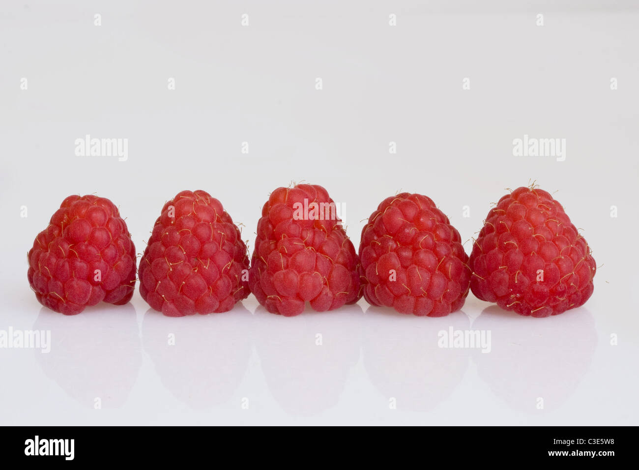 Raspberries in a row Stock Photo - Alamy