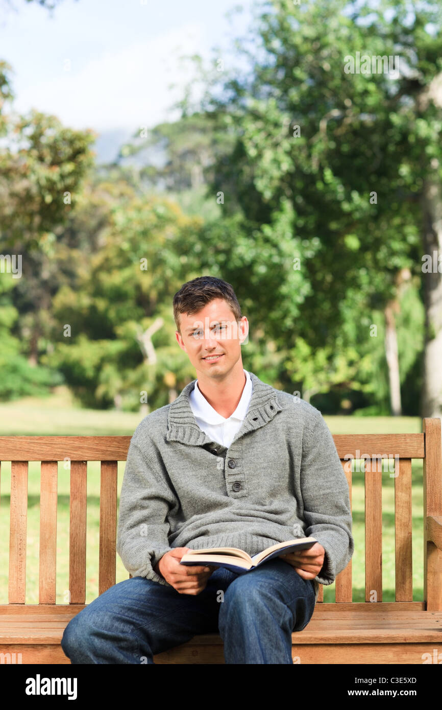 Young man reading his book on the bench Stock Photo - Alamy