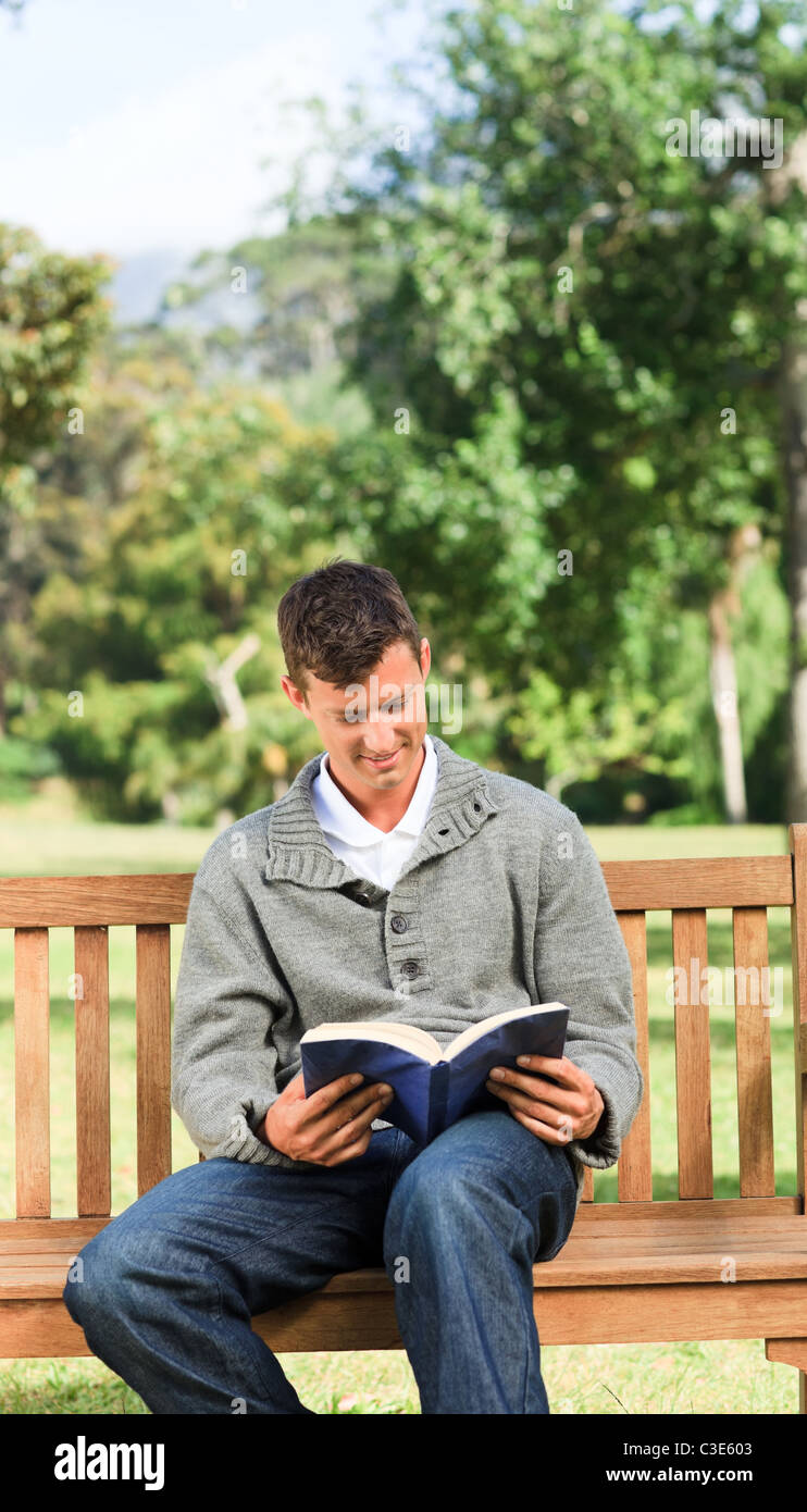 Man reading his book on the bench Stock Photo - Alamy