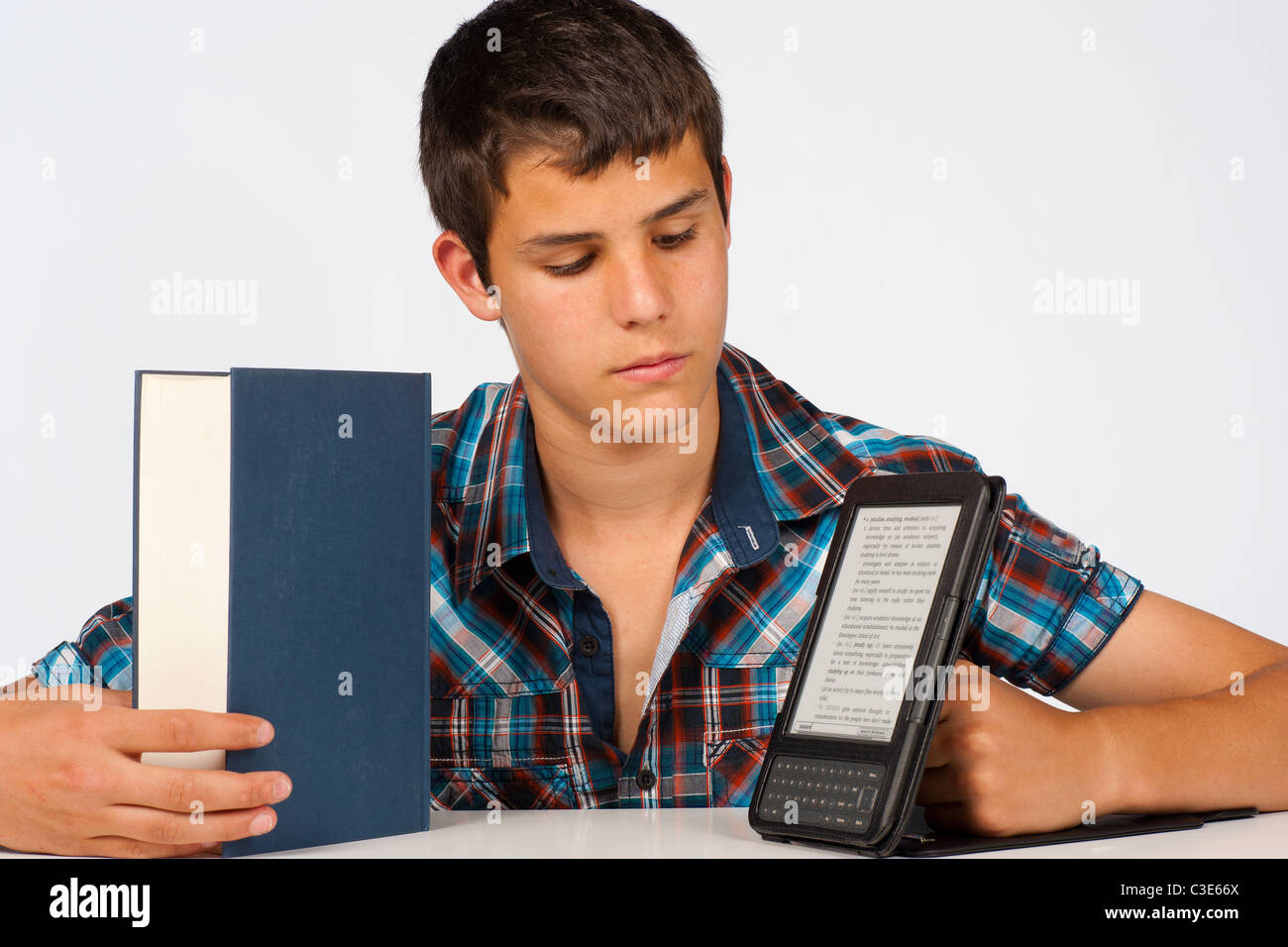 Student comparing a traditional book with its modern version Stock ...