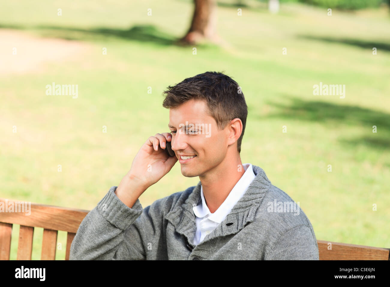 Man phoning on the bench Stock Photo - Alamy