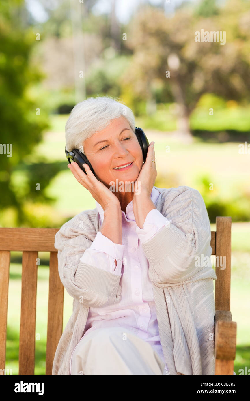 Senior woman listening to some music Stock Photo - Alamy