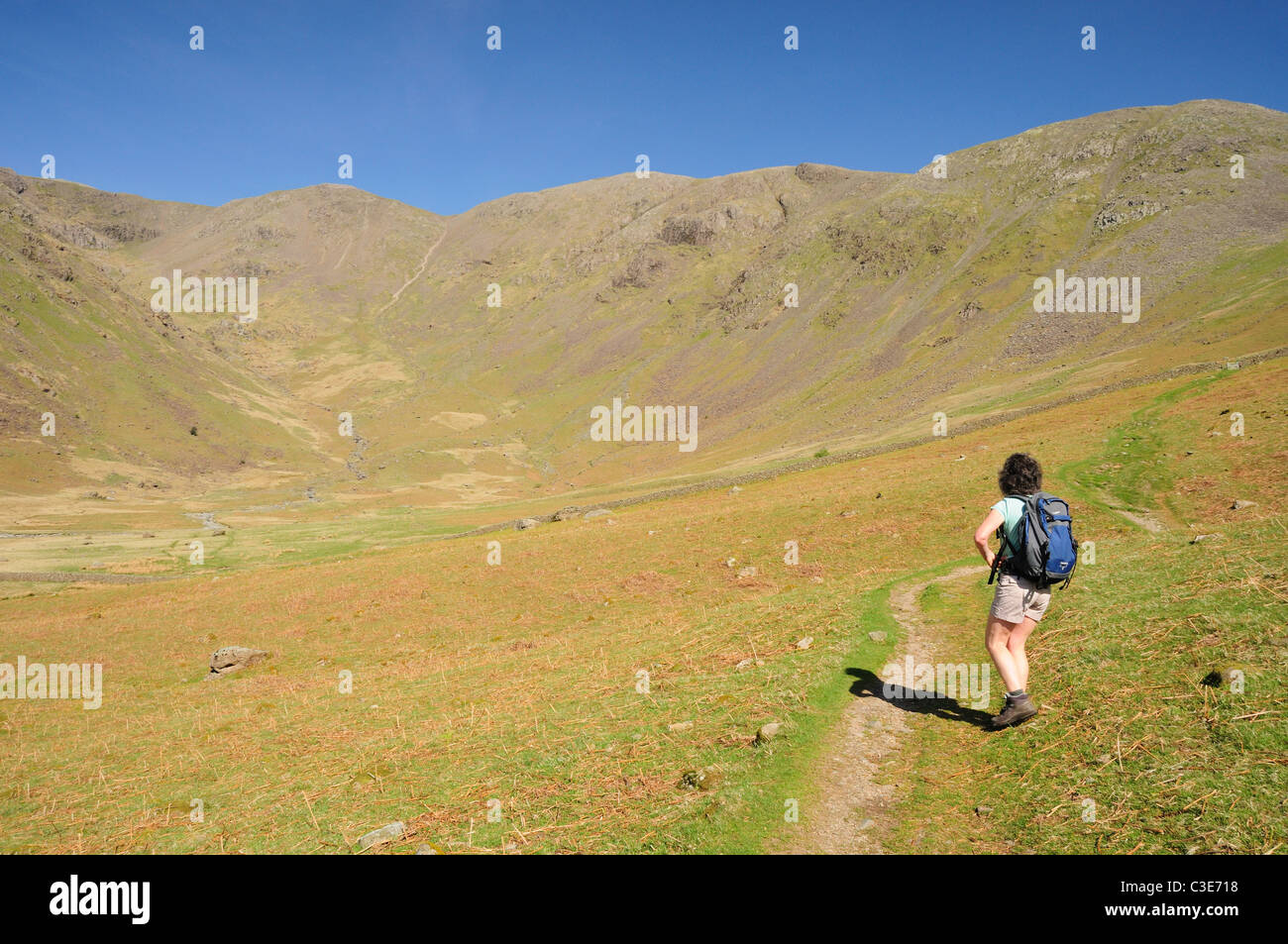 Walker in the Mosedale Valley on a sunny day in the English Lake ...