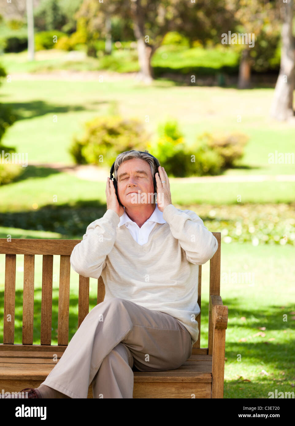 Retired man listening to some music Stock Photo - Alamy