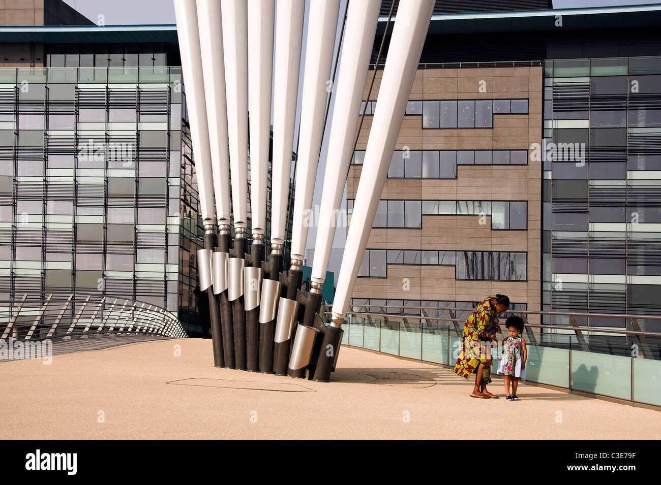 Woman and child crossing the new footbridge, Media City, Salford Quays ...