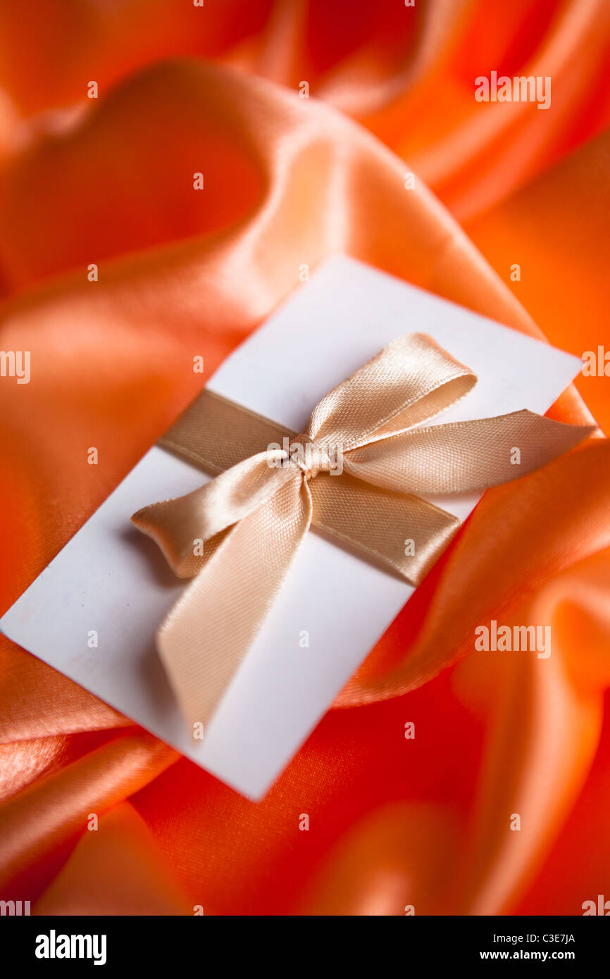 letter with golden ribbon on red satin Stock Photo - Alamy