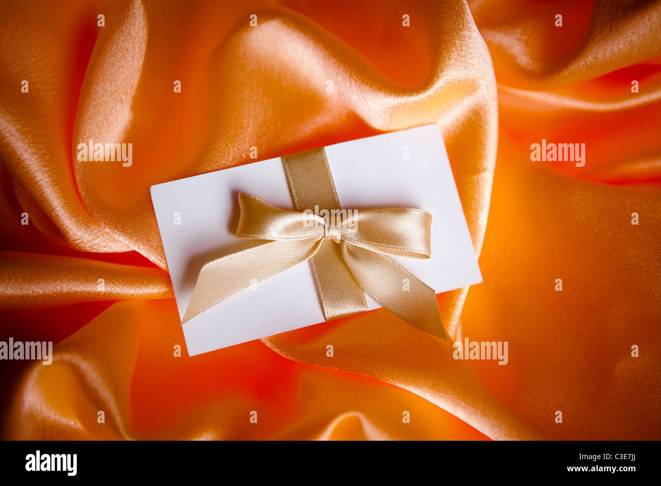 letter with golden ribbon on red satin Stock Photo - Alamy