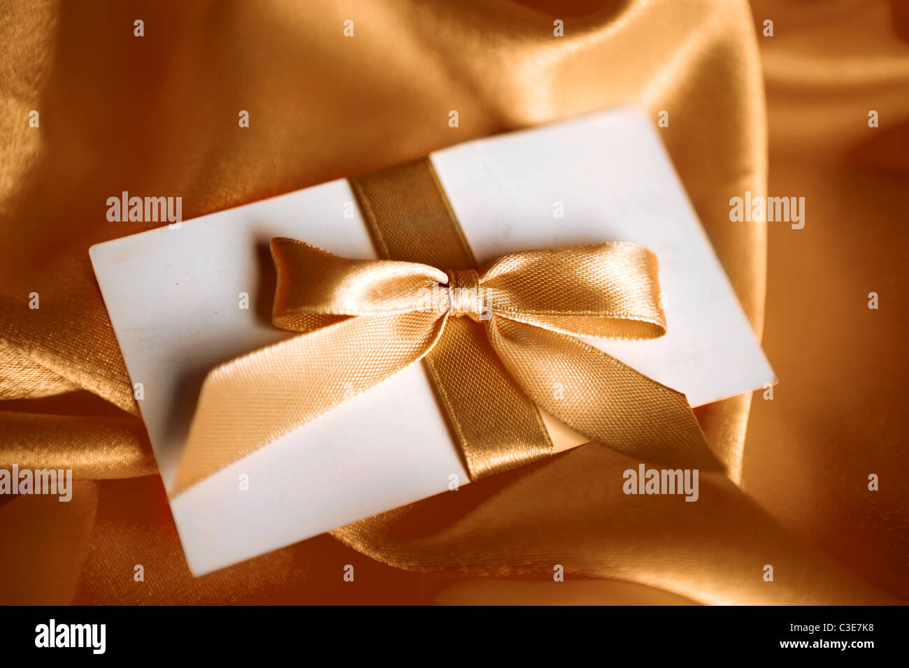letter with golden ribbon on red satin Stock Photo - Alamy