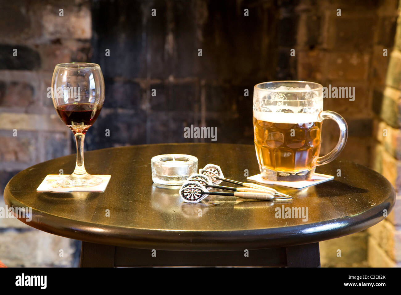 Pint beer glass, wine glass and darts in an English Pub Stock Photo - Alamy
