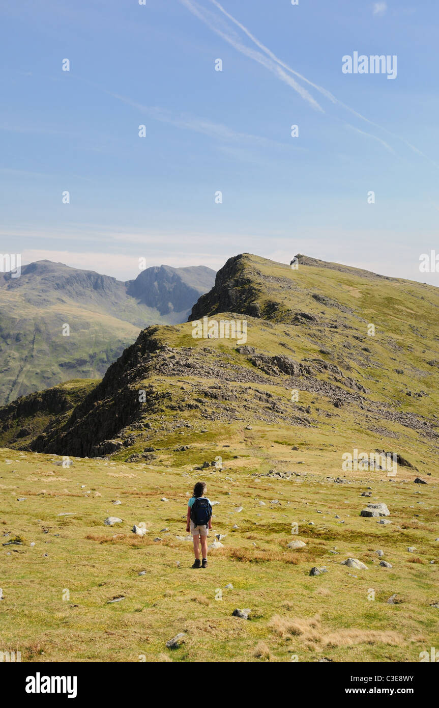Walker approaching the summit of Red Pike in the English Lake District ...