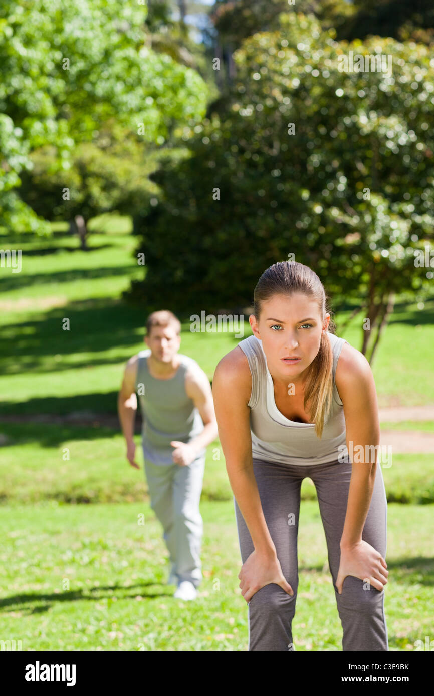 Exhausted couple in the park Stock Photo - Alamy