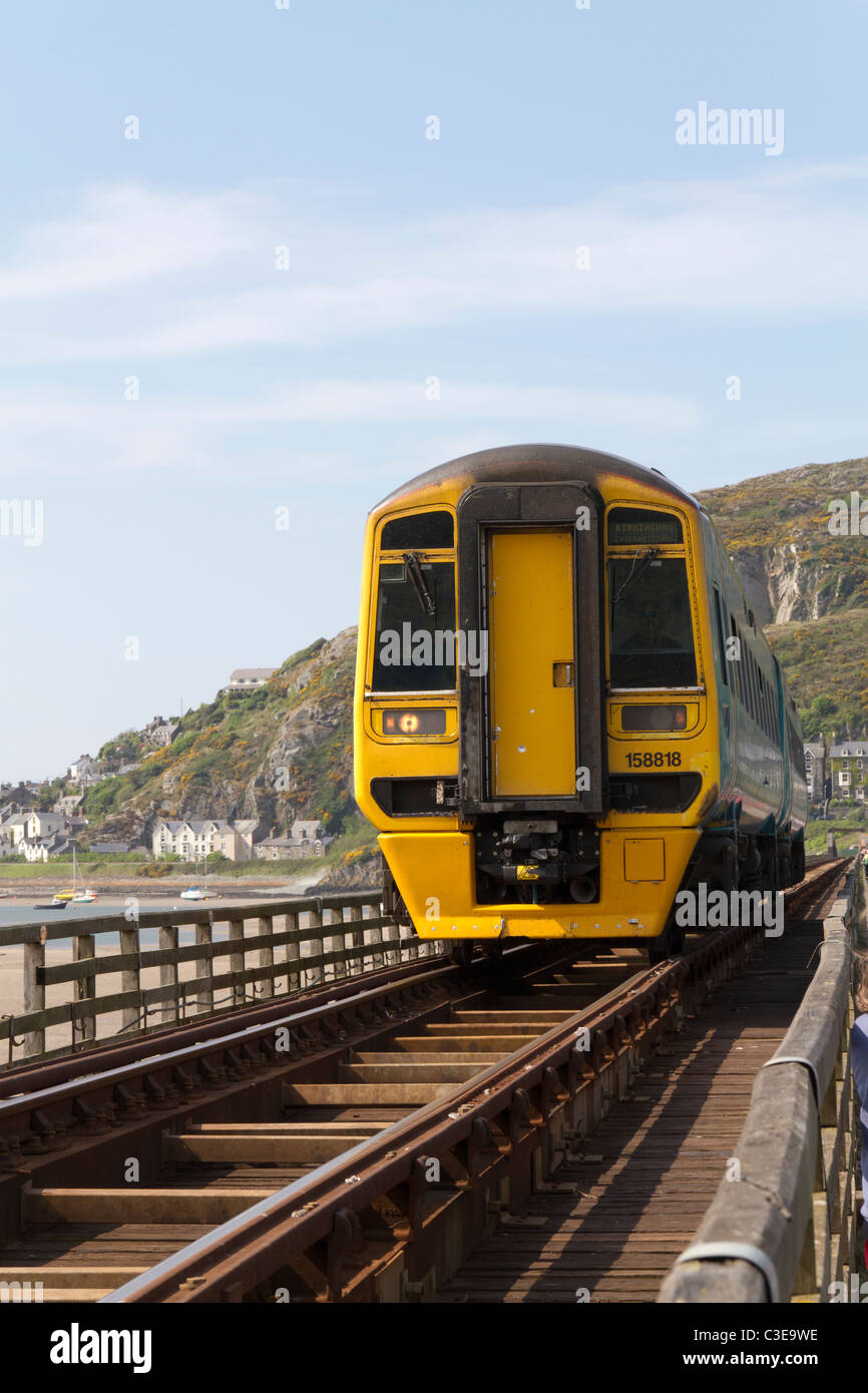 Train crossing the bridge across the Mawddach estuary in Barmouth Wales ...