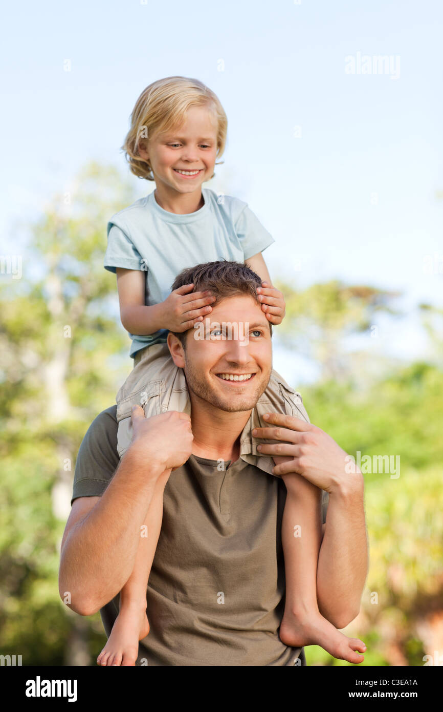 Father giving son a piggyback Stock Photo - Alamy