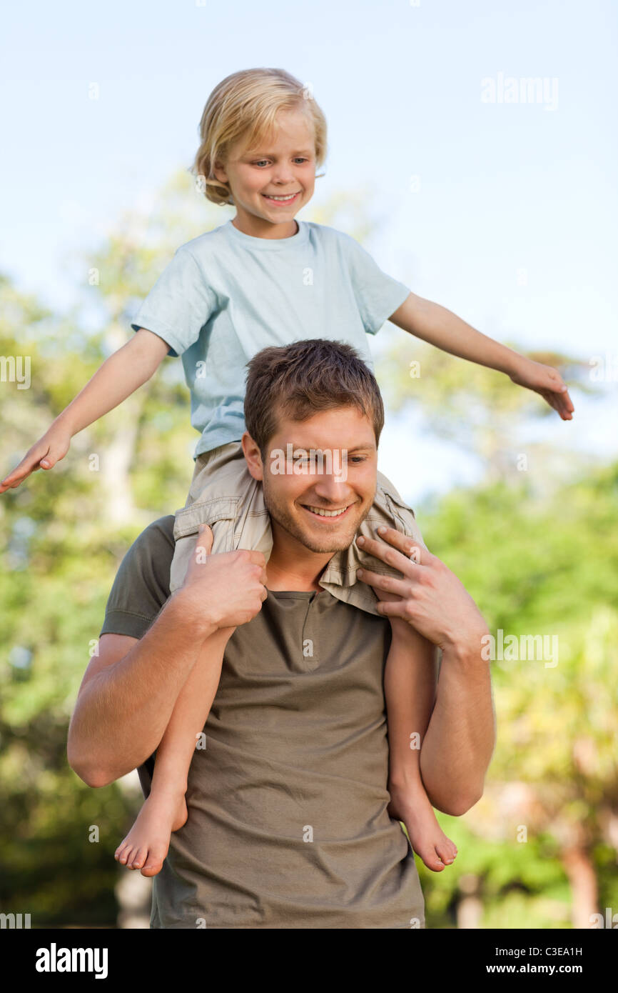 Father giving son a piggyback Stock Photo - Alamy