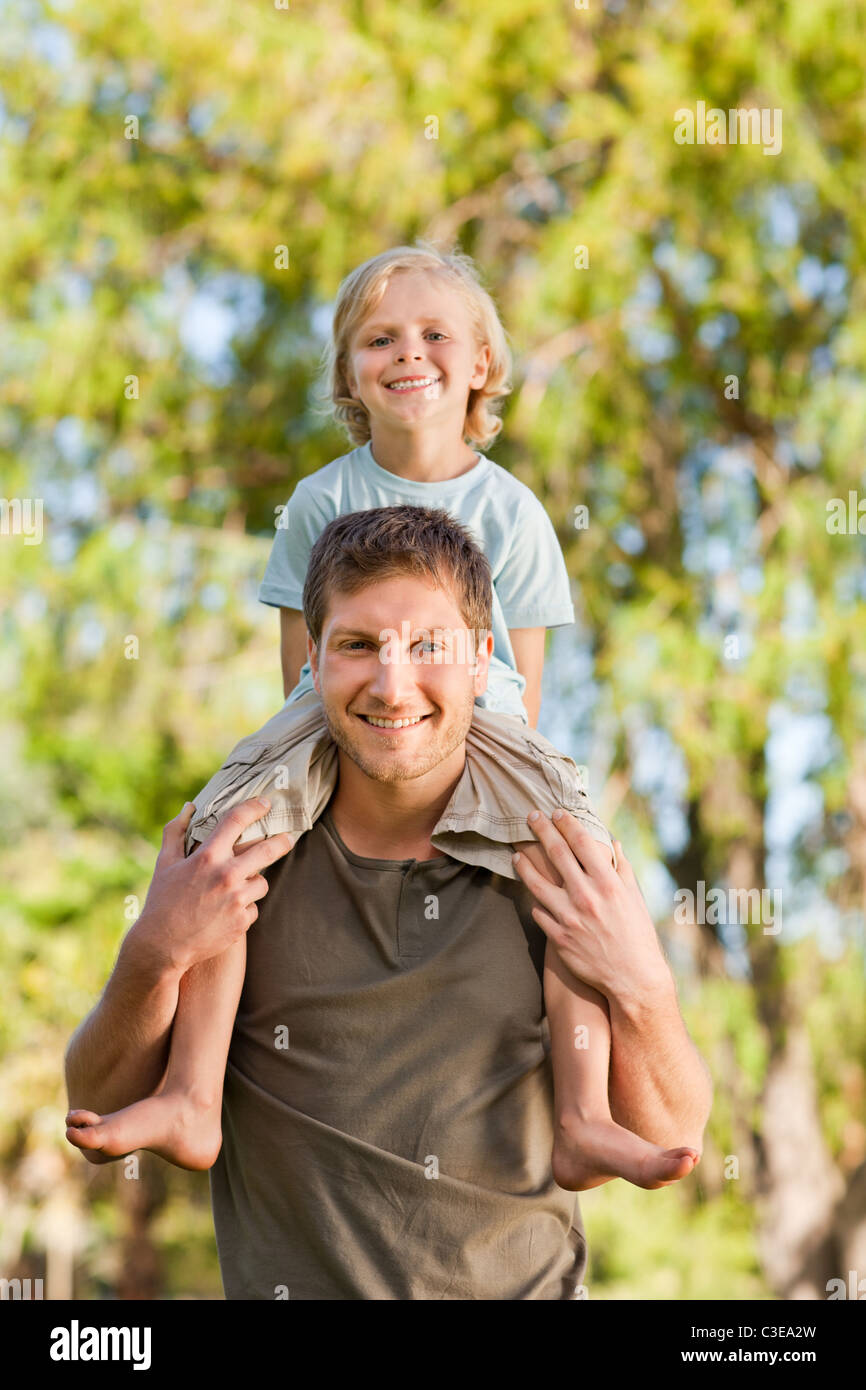 Happy father giving son a piggyback Stock Photo - Alamy