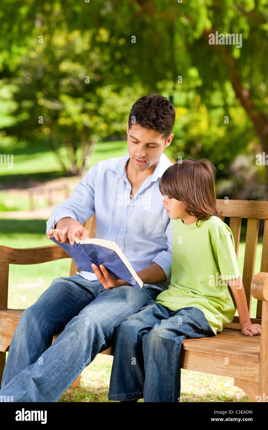 Father with his son reading a book Stock Photo - Alamy