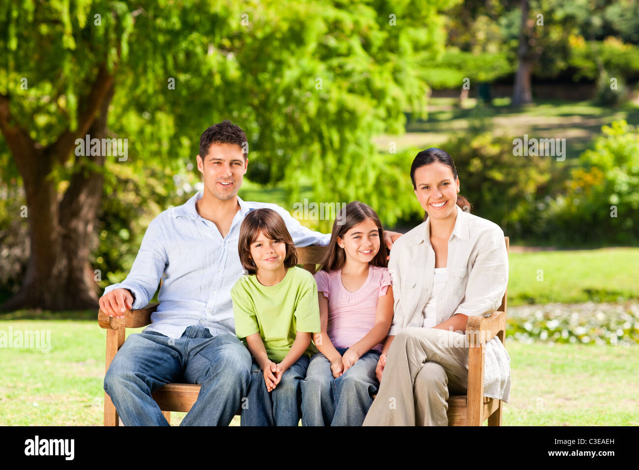 Family on the bench Stock Photo - Alamy