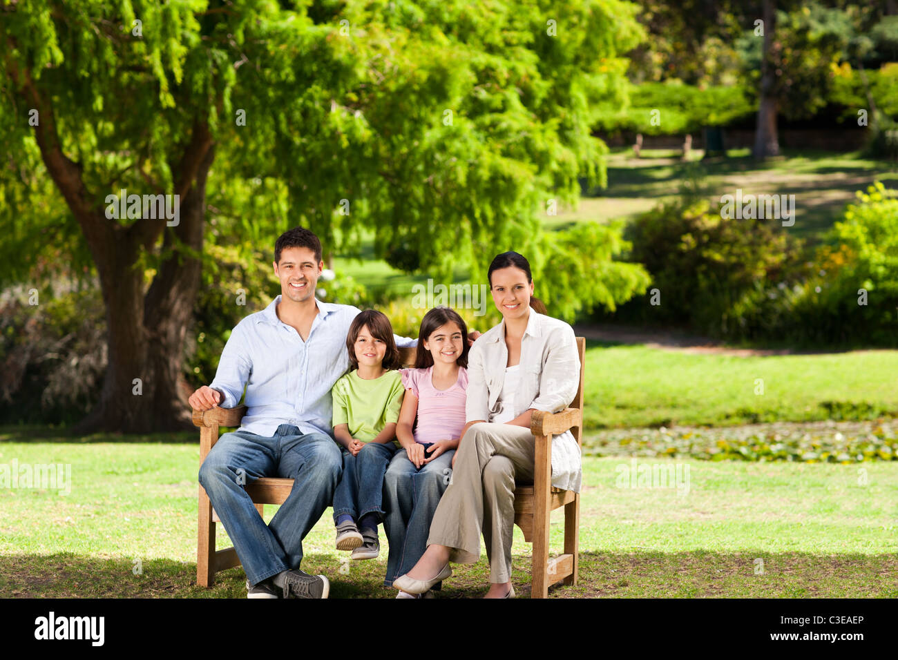 Family on the bench Stock Photo - Alamy