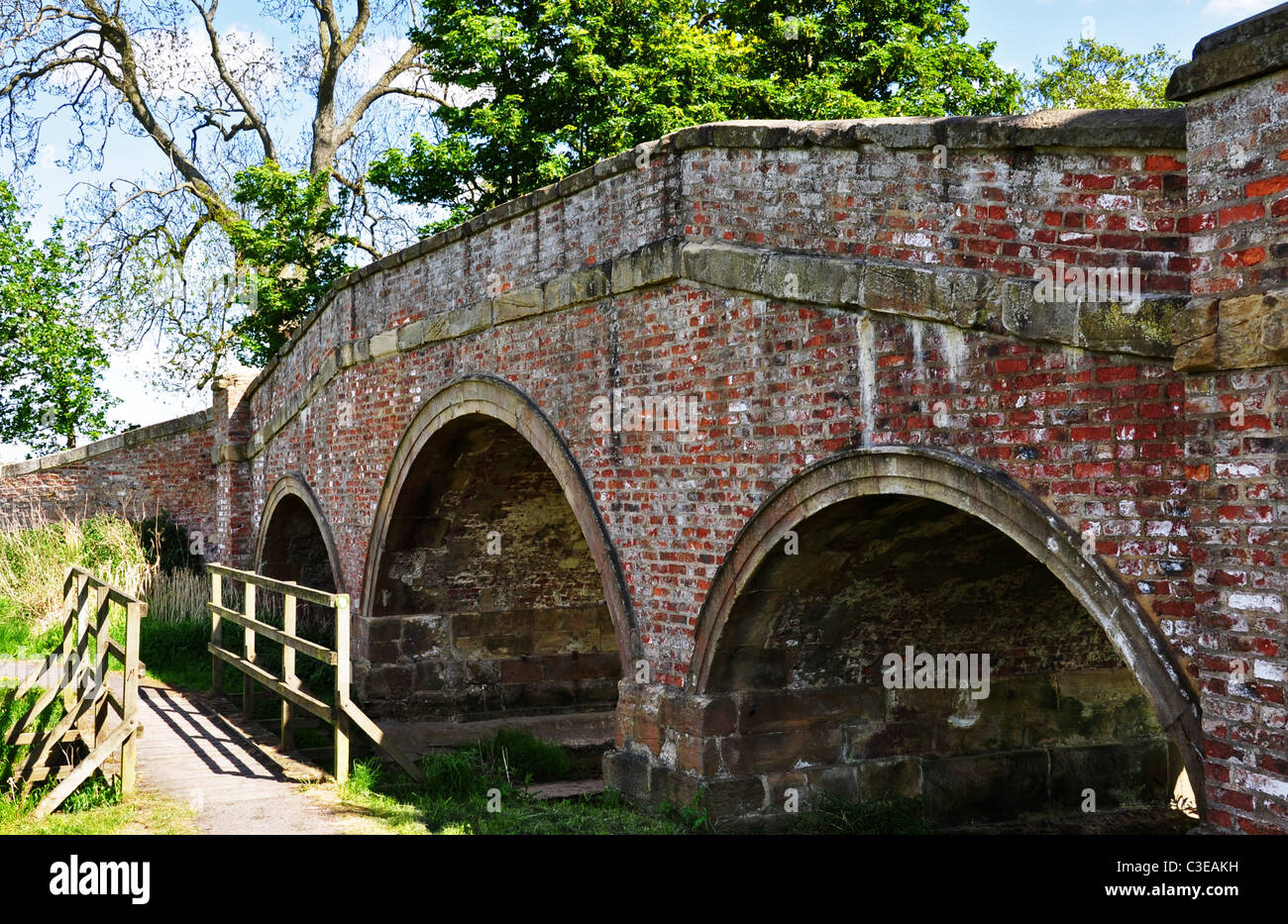 Old road bridge with small footbridge at the side Stock Photo - Alamy