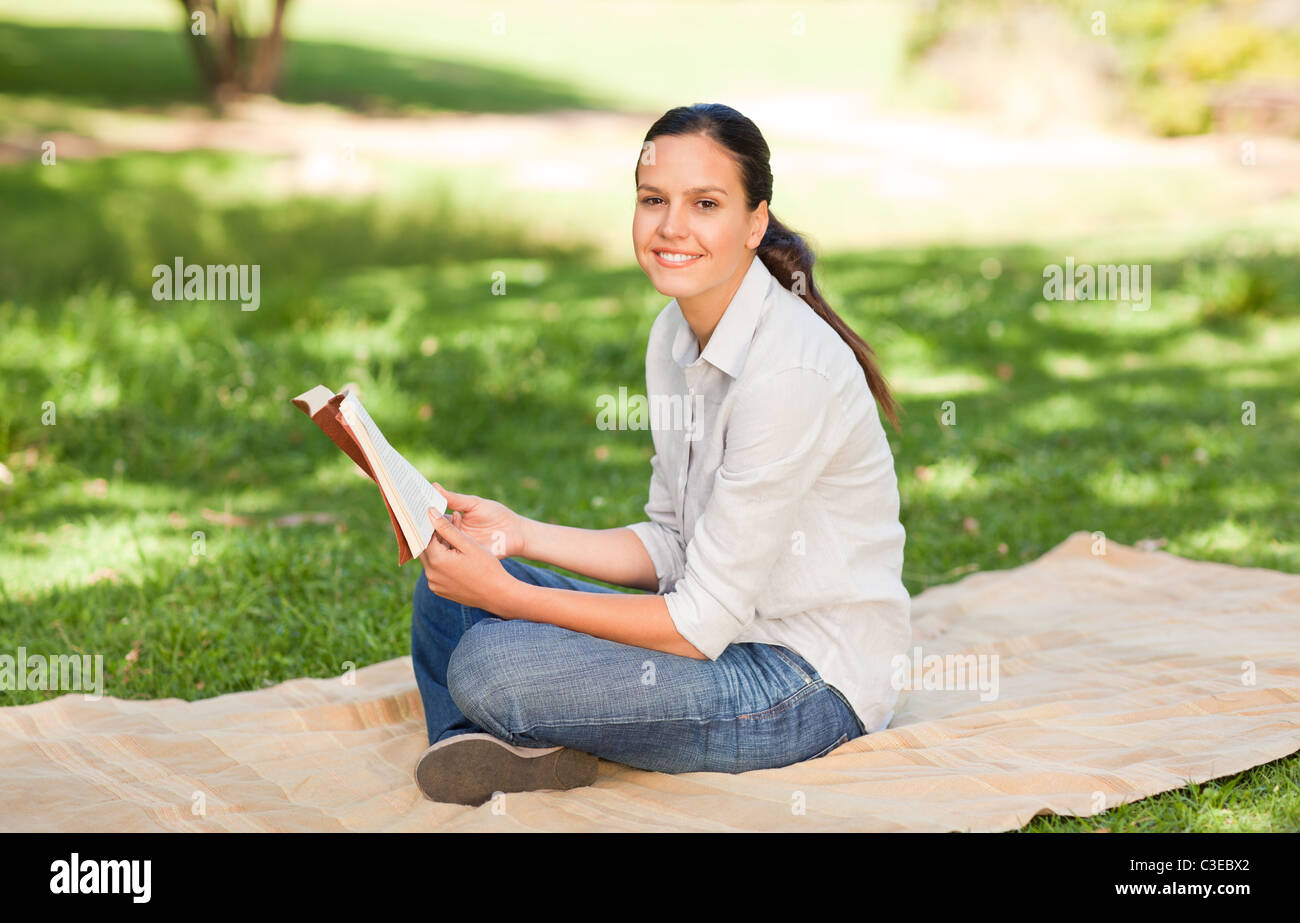 Woman reading in the park Stock Photo - Alamy