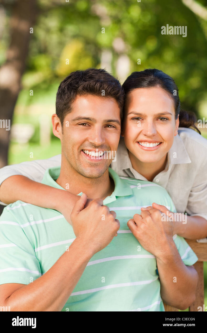 Woman huging her boyfriend Stock Photo - Alamy