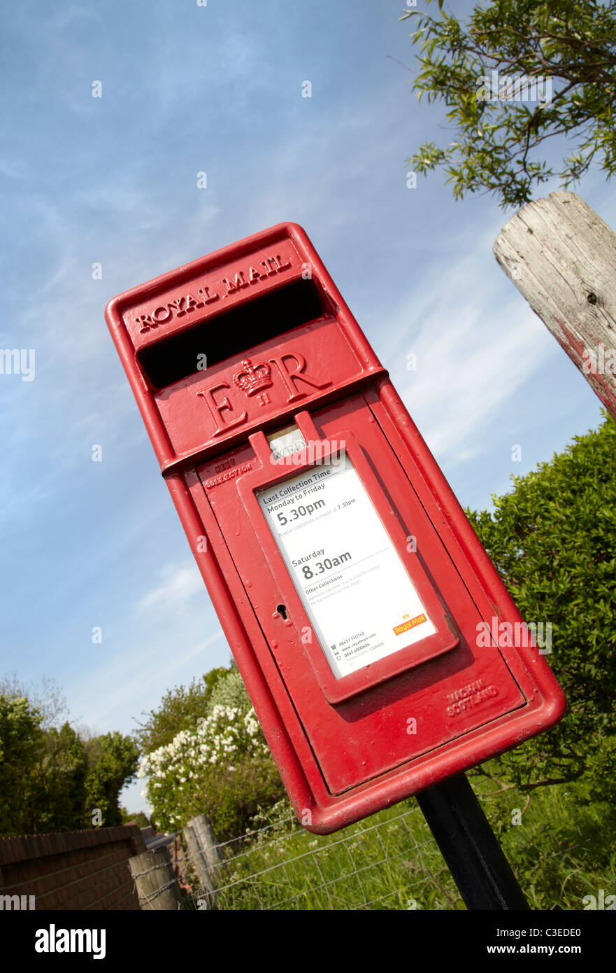 Royal mail post box on road side in rural setting. Showing small red ...