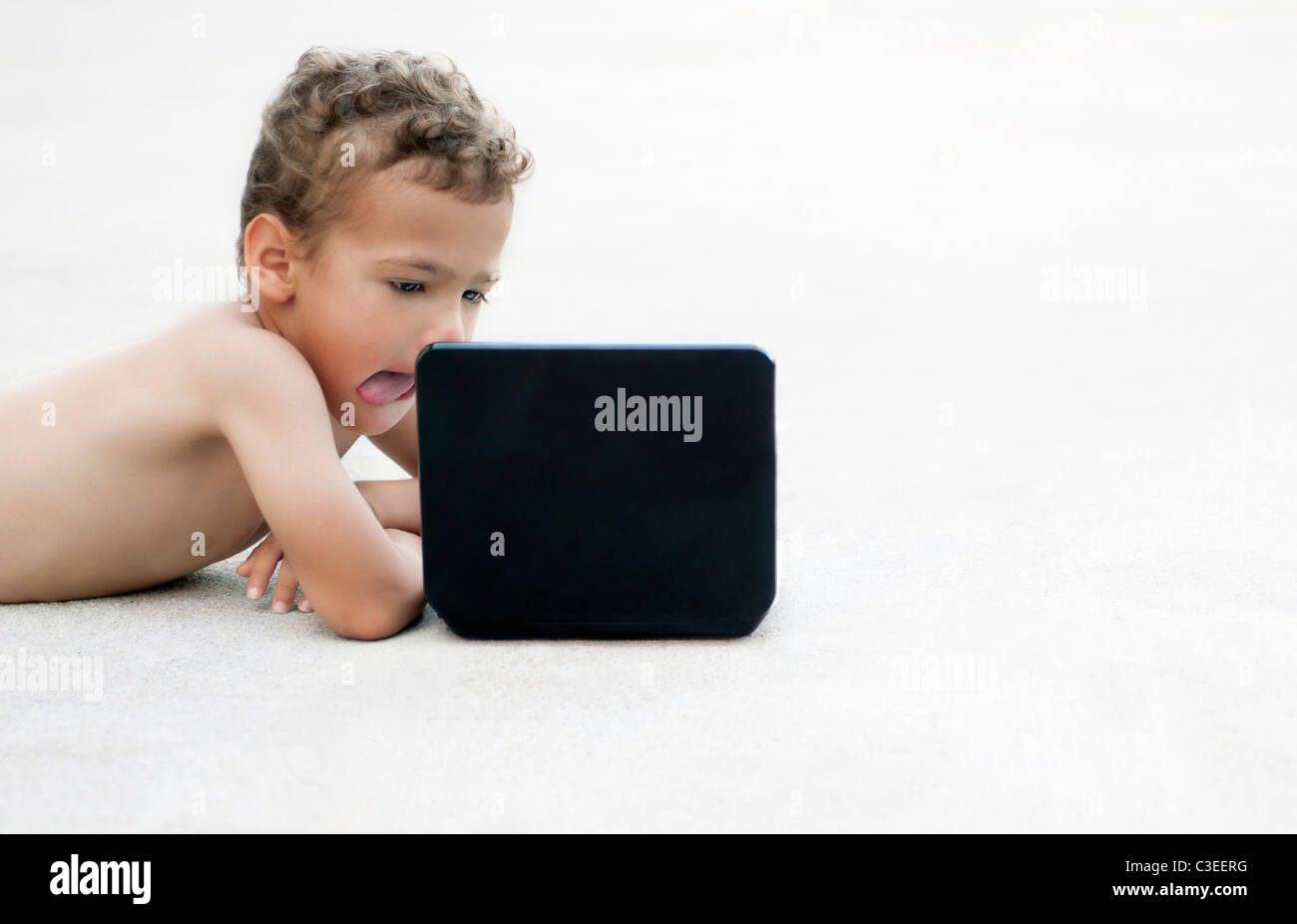 Child watching a movie in a portable dvd player Stock Photo - Alamy