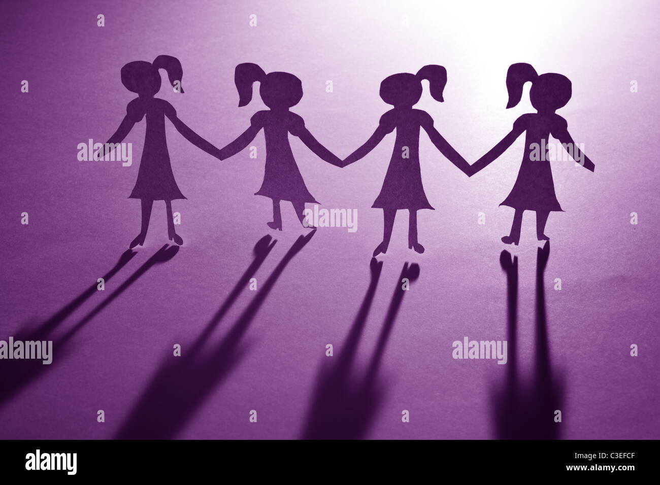 Paper Chain girls, concept of Teamwork Stock Photo - Alamy