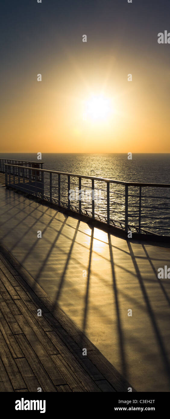 Photograph of a ship rail during sunset Stock Photo - Alamy