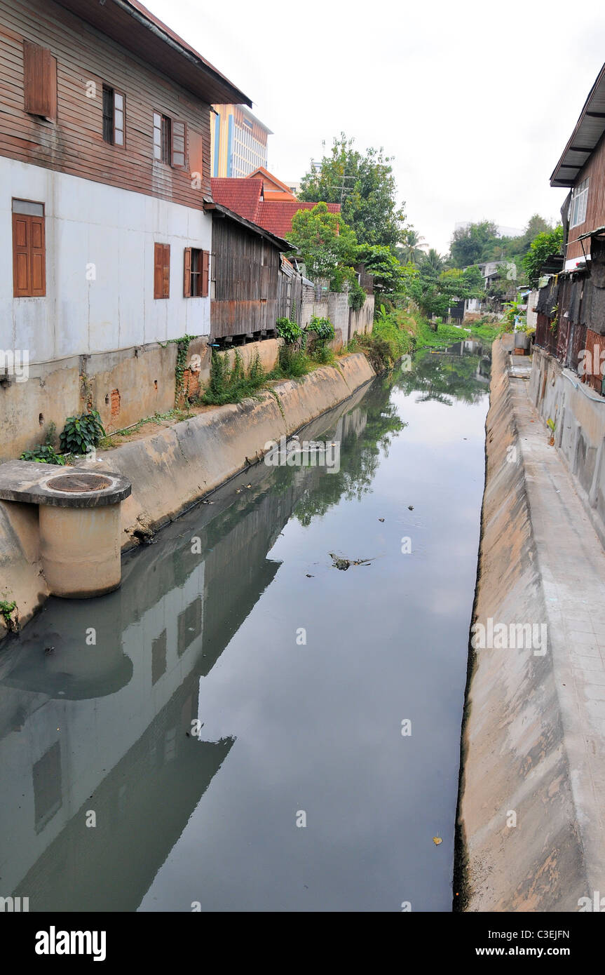 A small canal runs between two simple buildings Stock Photo - Alamy
