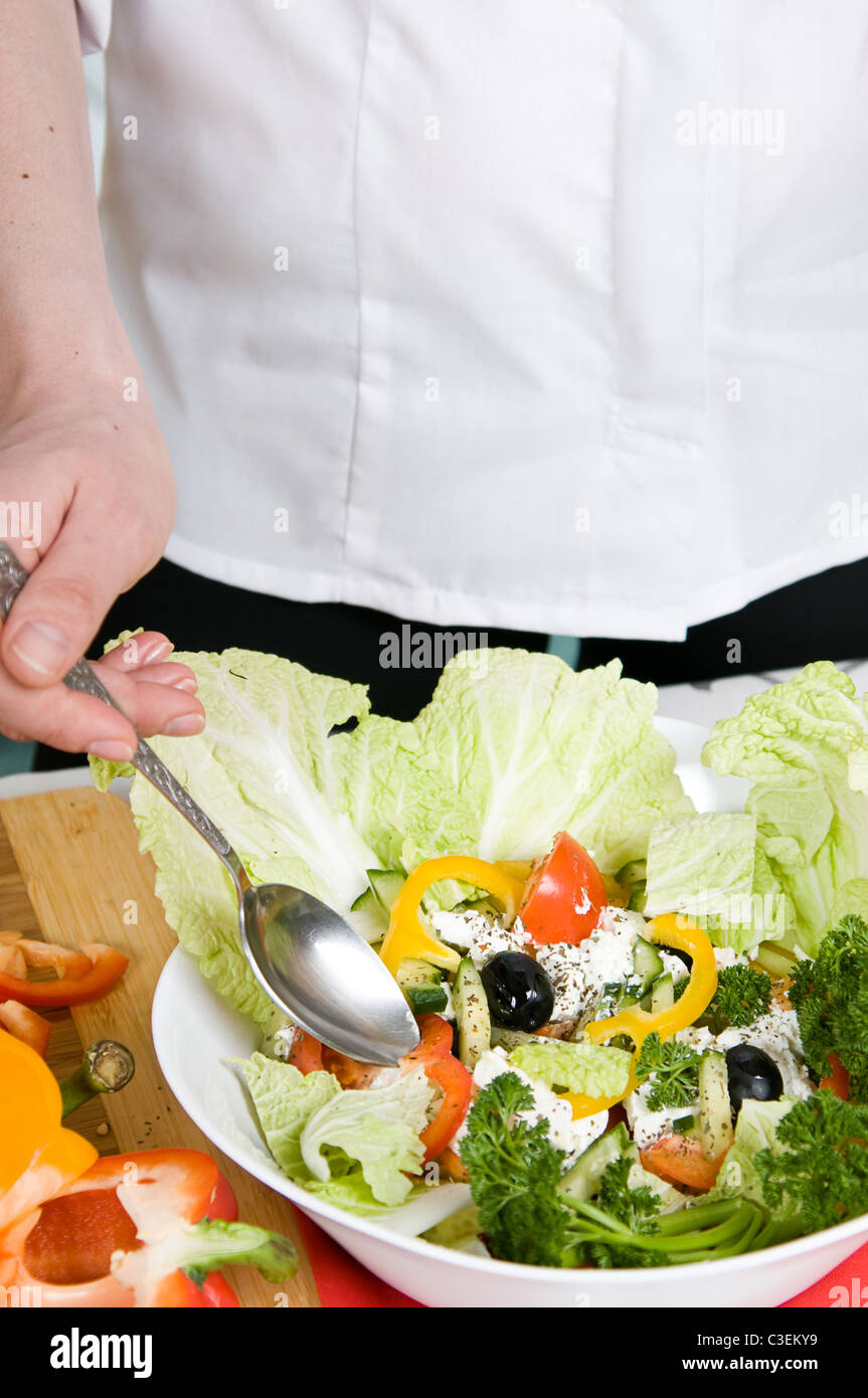 Preparation of salad from cheese and fresh vegetables Stock Photo - Alamy