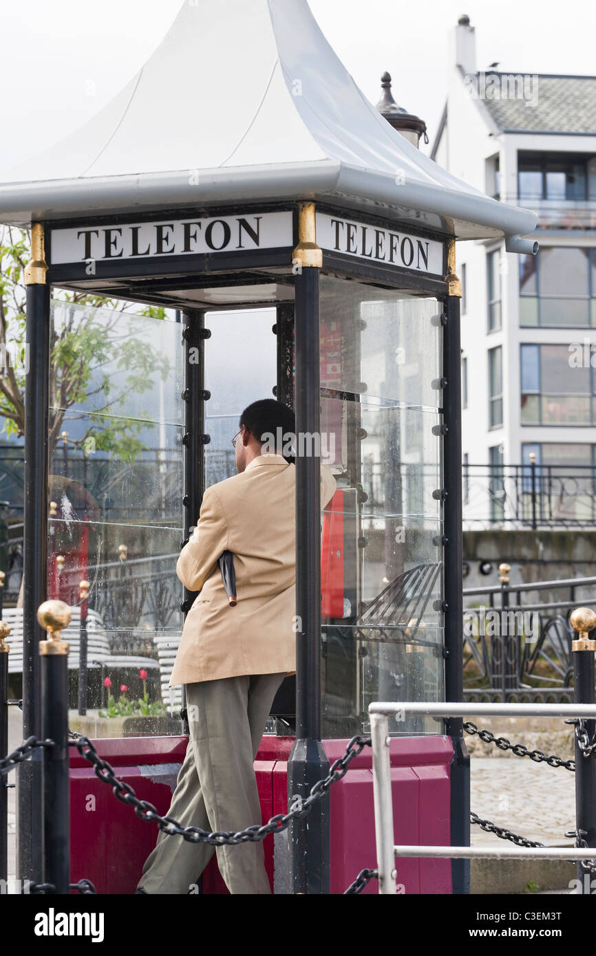 Man in phone booth Stock Photo - Alamy