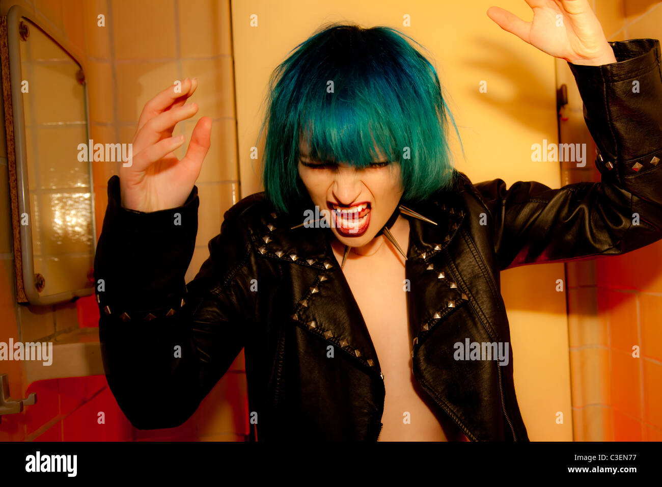 Gothic rock girl with blue hair putting on the moves Stock Photo - Alamy