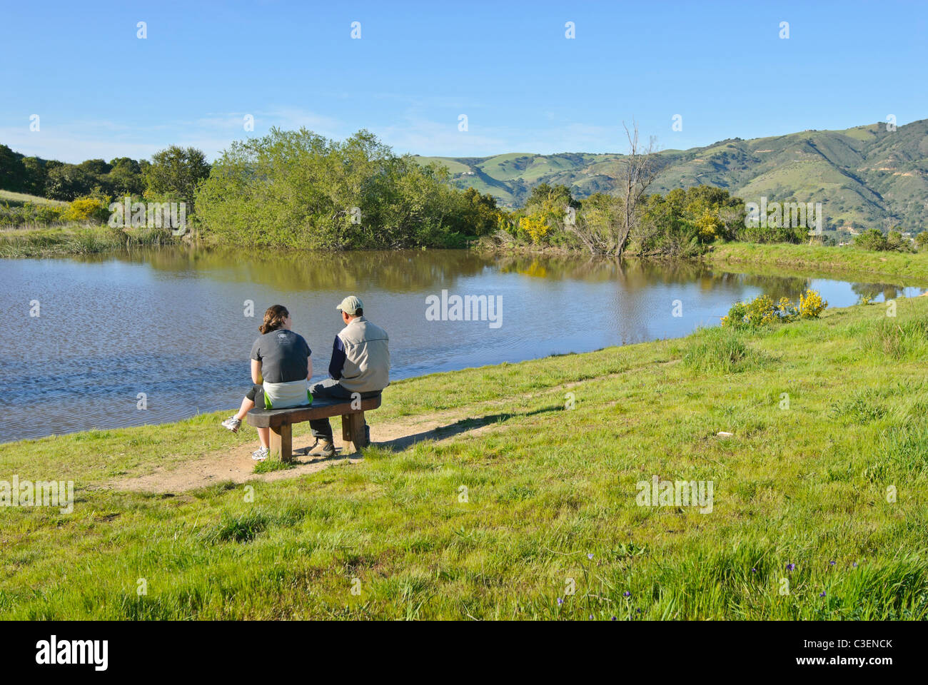 Couple enjoying the view of Mesa Pond at Garland Ranch Park, Monterey ...