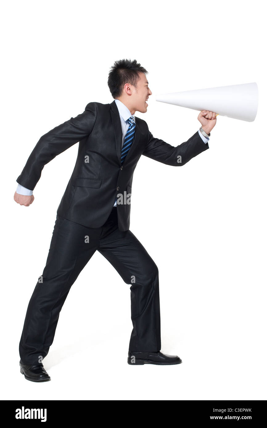 Portrait of a businessman shouting into a megaphone Stock Photo - Alamy