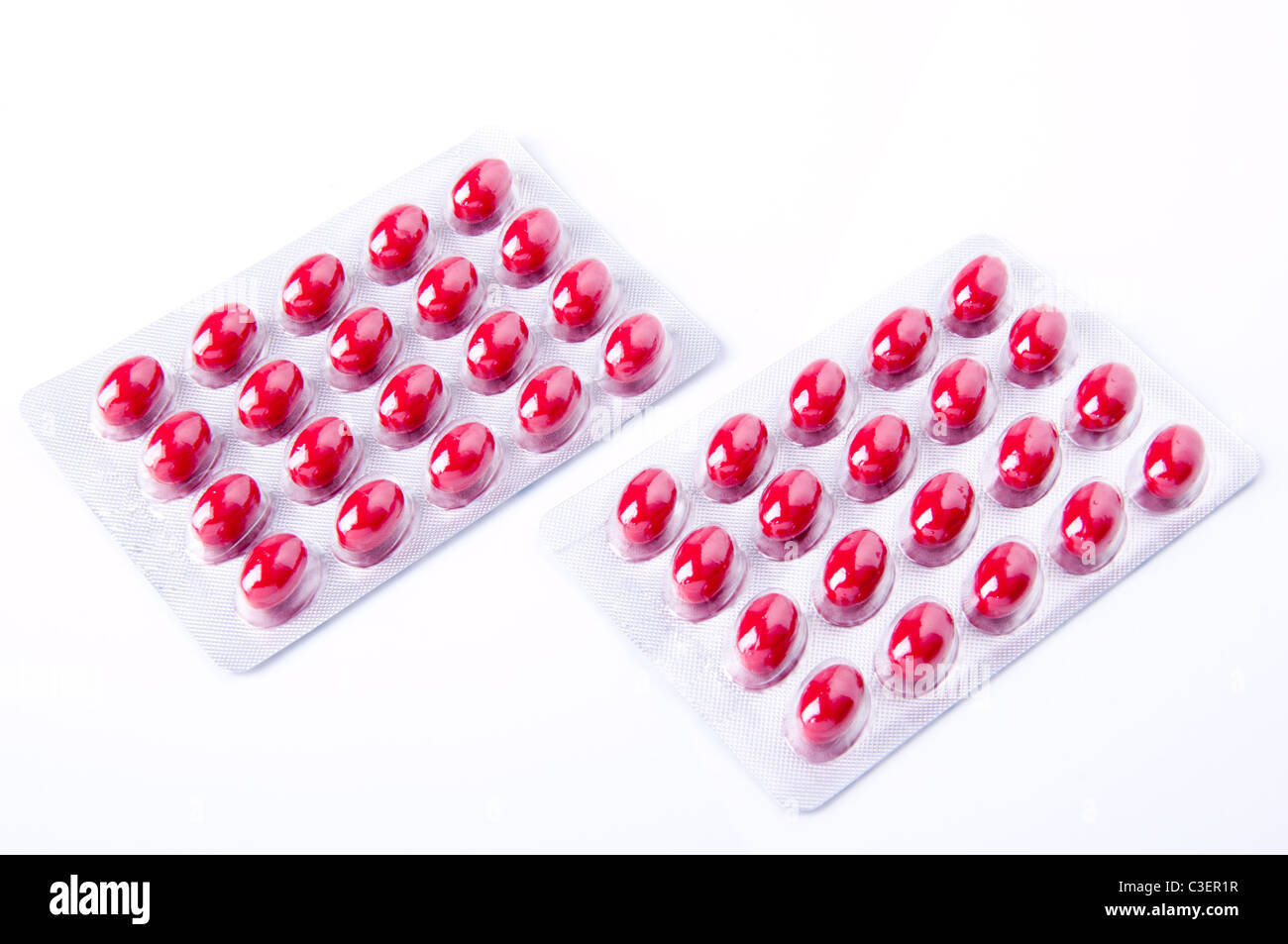 packaging of medicine capsules red on white background Stock Photo - Alamy