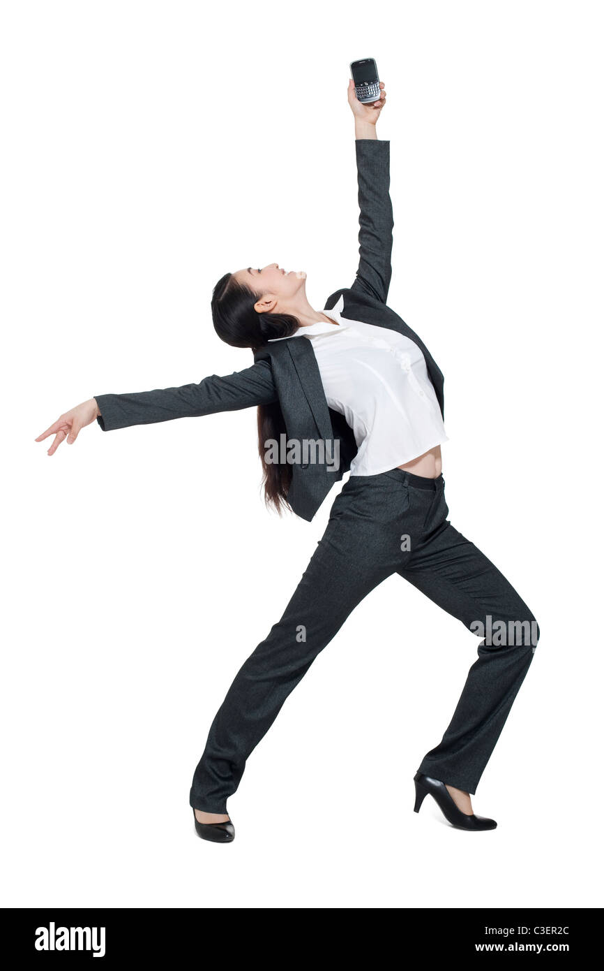A dancing businesswoman holding a mobile phone Stock Photo - Alamy