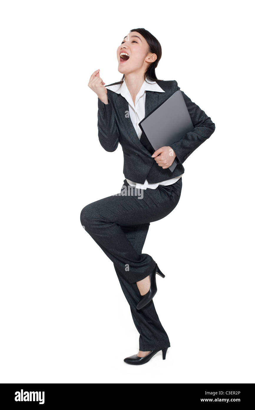 A dancing businesswoman holding a file folder Stock Photo - Alamy