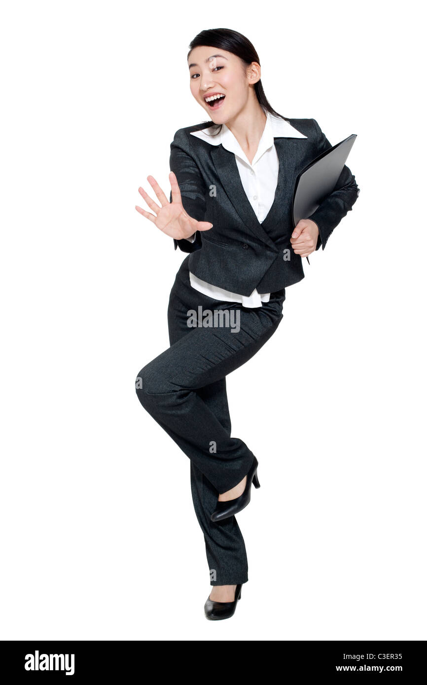 A dancing businesswoman holding a file folder Stock Photo - Alamy