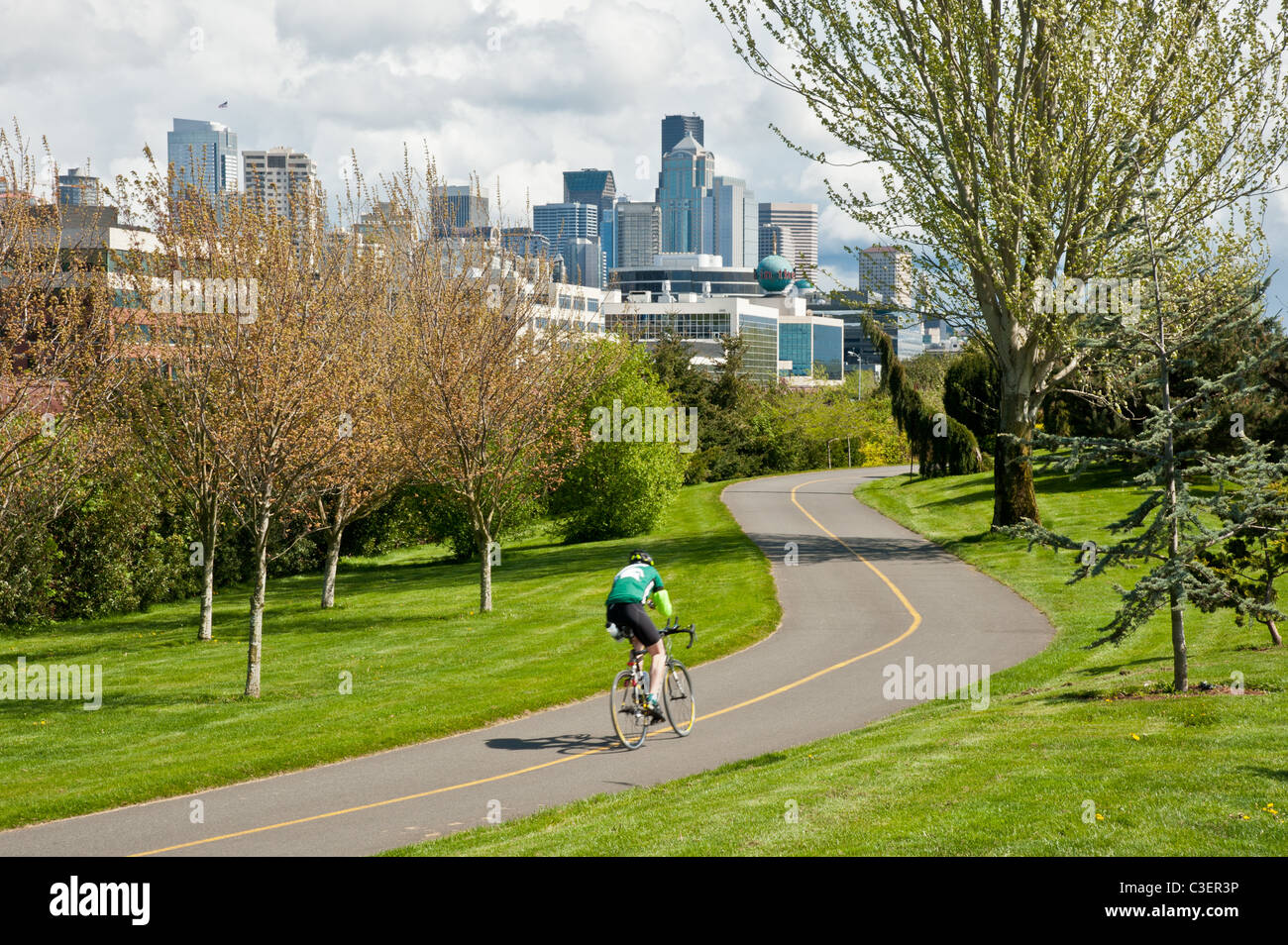 A bicycle speeding up a curve in a waterfront park with downtown ...