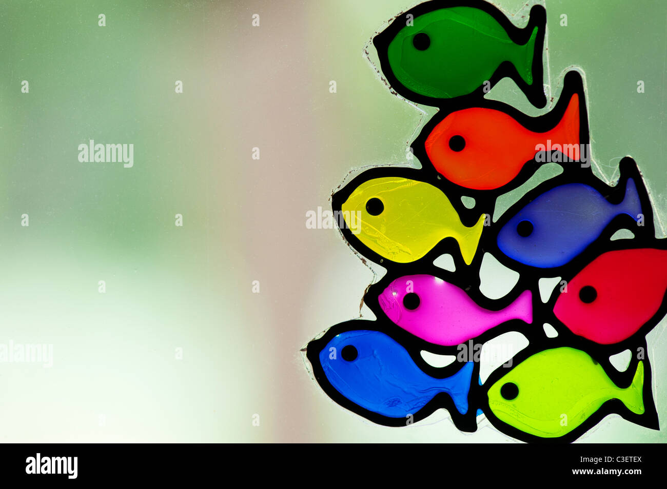 Colourful fish sticker on a glass window pane Stock Photo - Alamy